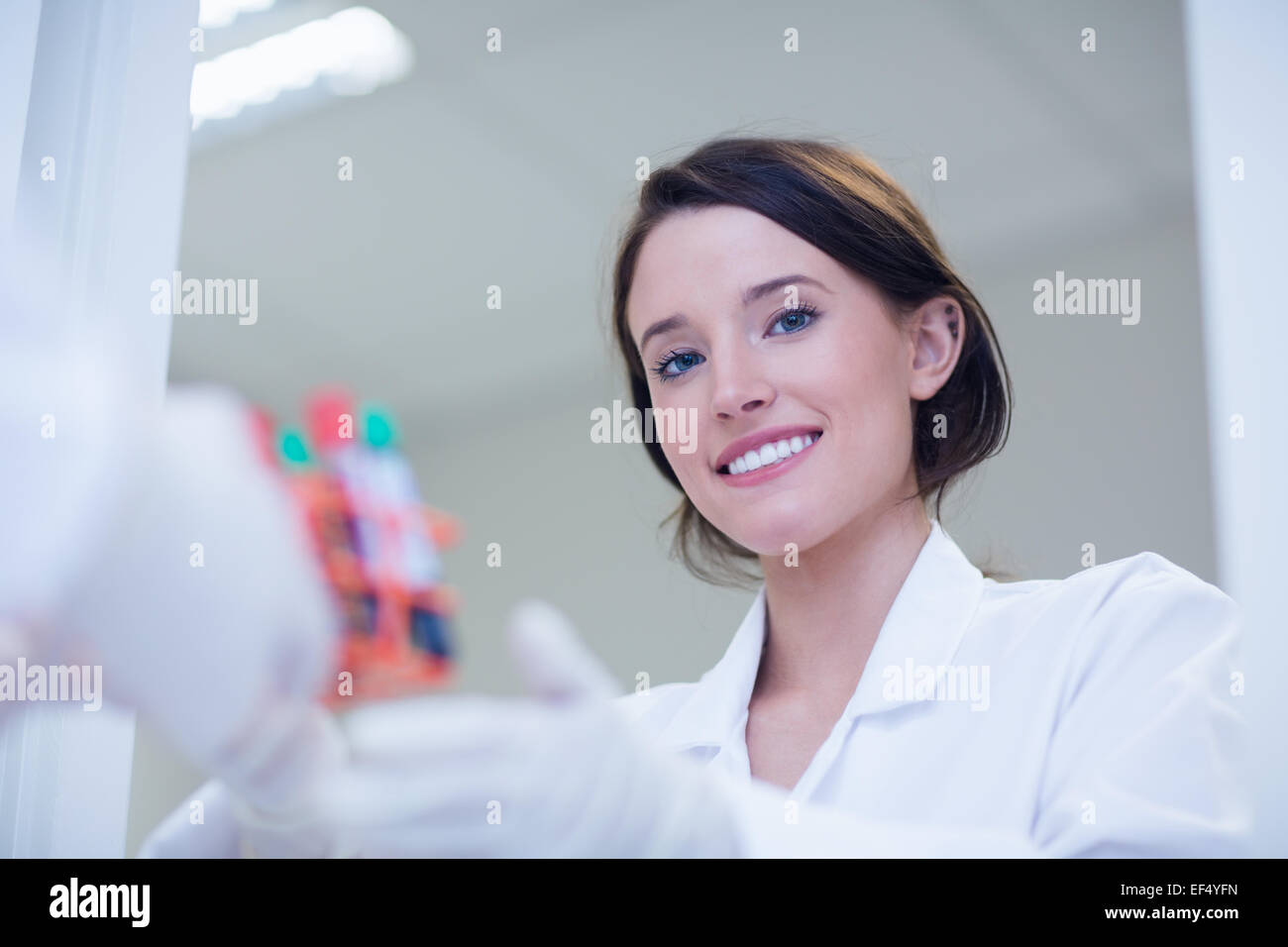 Young female biologist smiling at the camera Stock Photo - Alamy