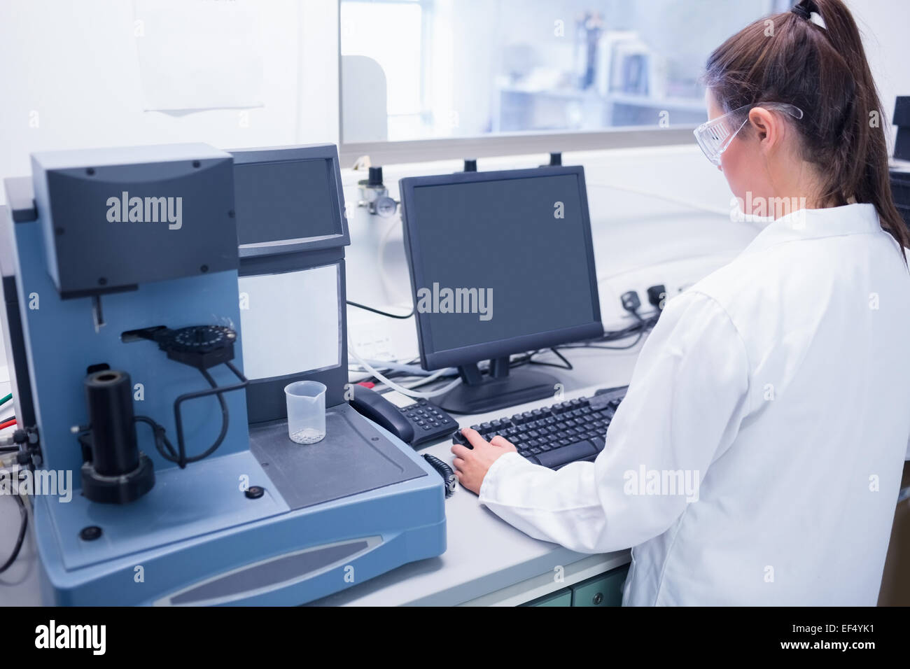 Young scientist typing on his computer Stock Photo - Alamy