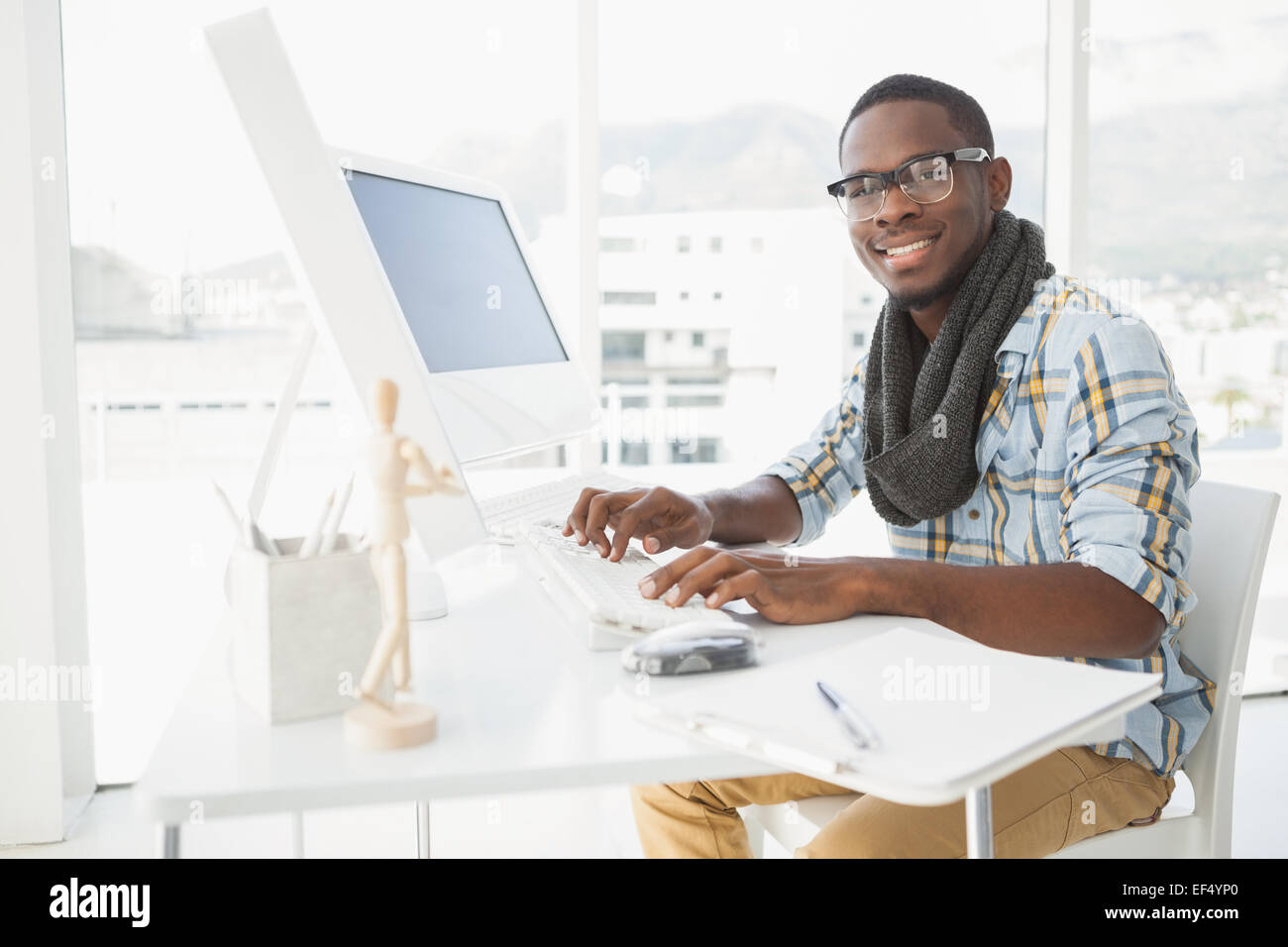 Smiling businessman typing on keyboard Stock Photo - Alamy
