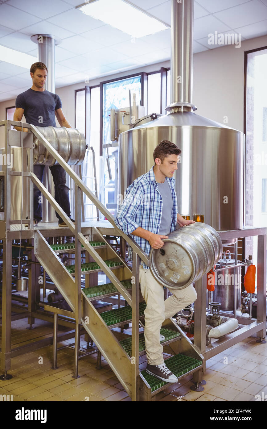 Young men carrying keg smiling at camera Stock Photo - Alamy