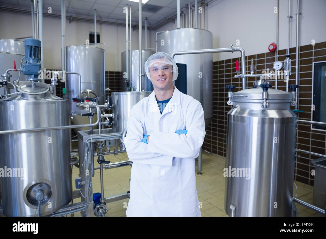 Scientist with arms crossed wearing protective glasses Stock Photo - Alamy
