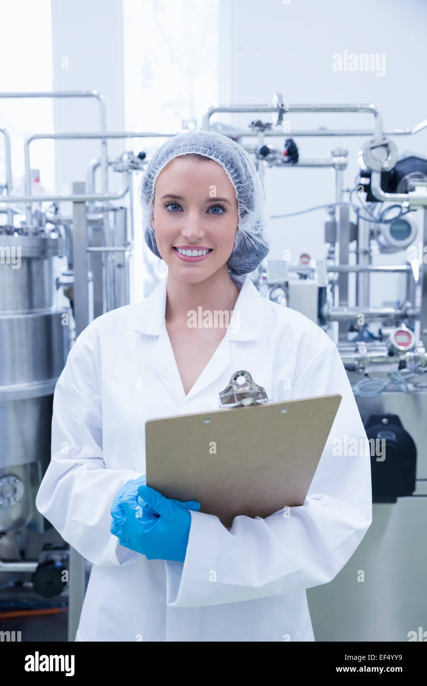 Portrait of a smiling scientist holding a clipboard Stock Photo - Alamy