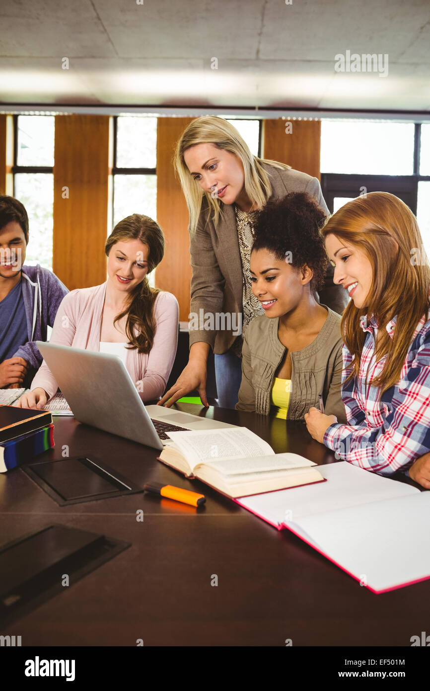 Professor teaching group of students in library Stock Photo - Alamy