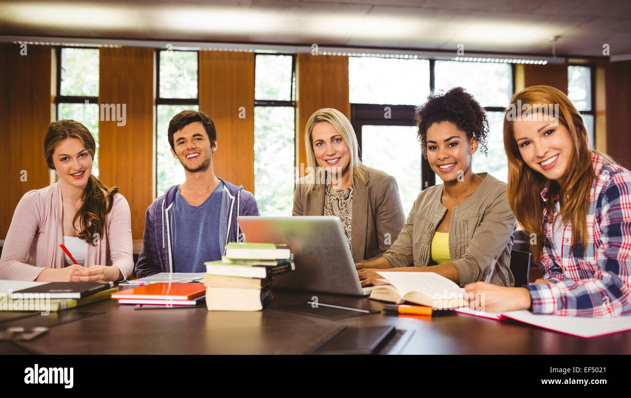 Smiling students working together on an assignment Stock Photo - Alamy