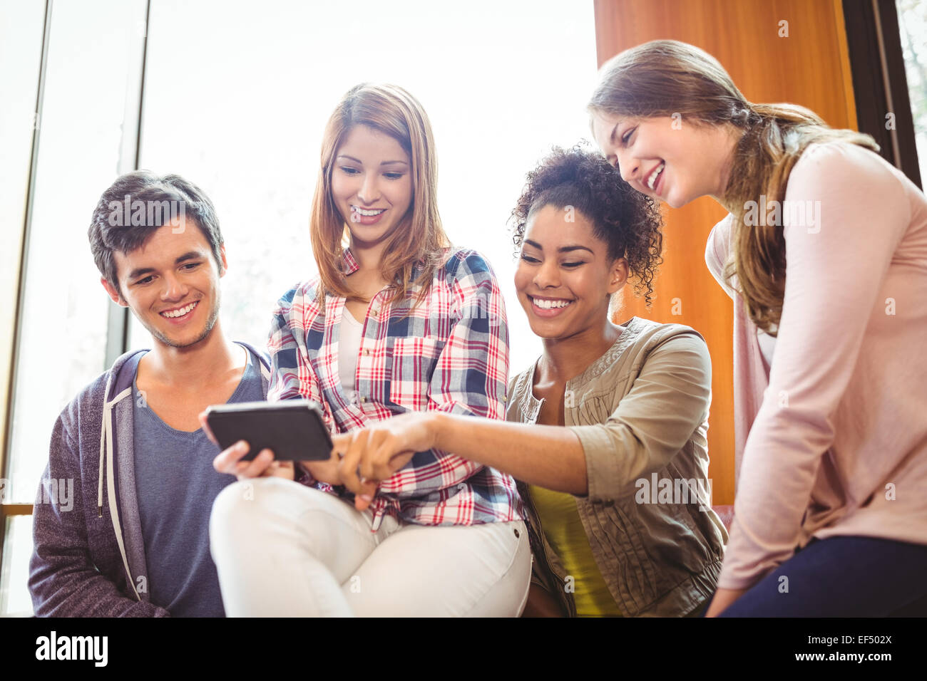 Happy student holding smartphone showing screen Stock Photo - Alamy