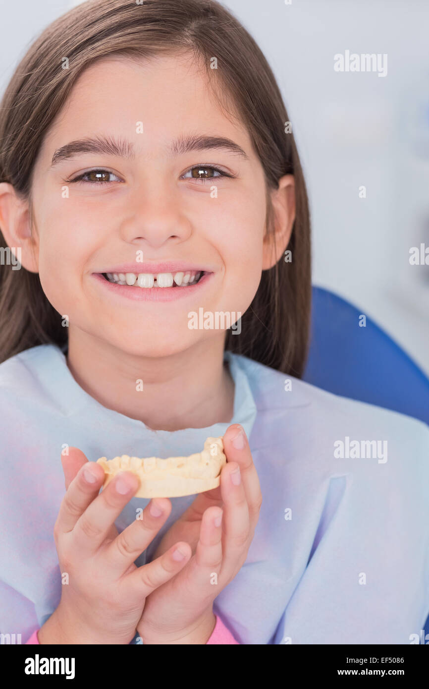 Smiling young patient holding teeth Stock Photo - Alamy