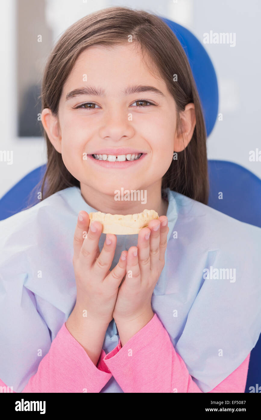 Smiling young patient holding teeth Stock Photo - Alamy