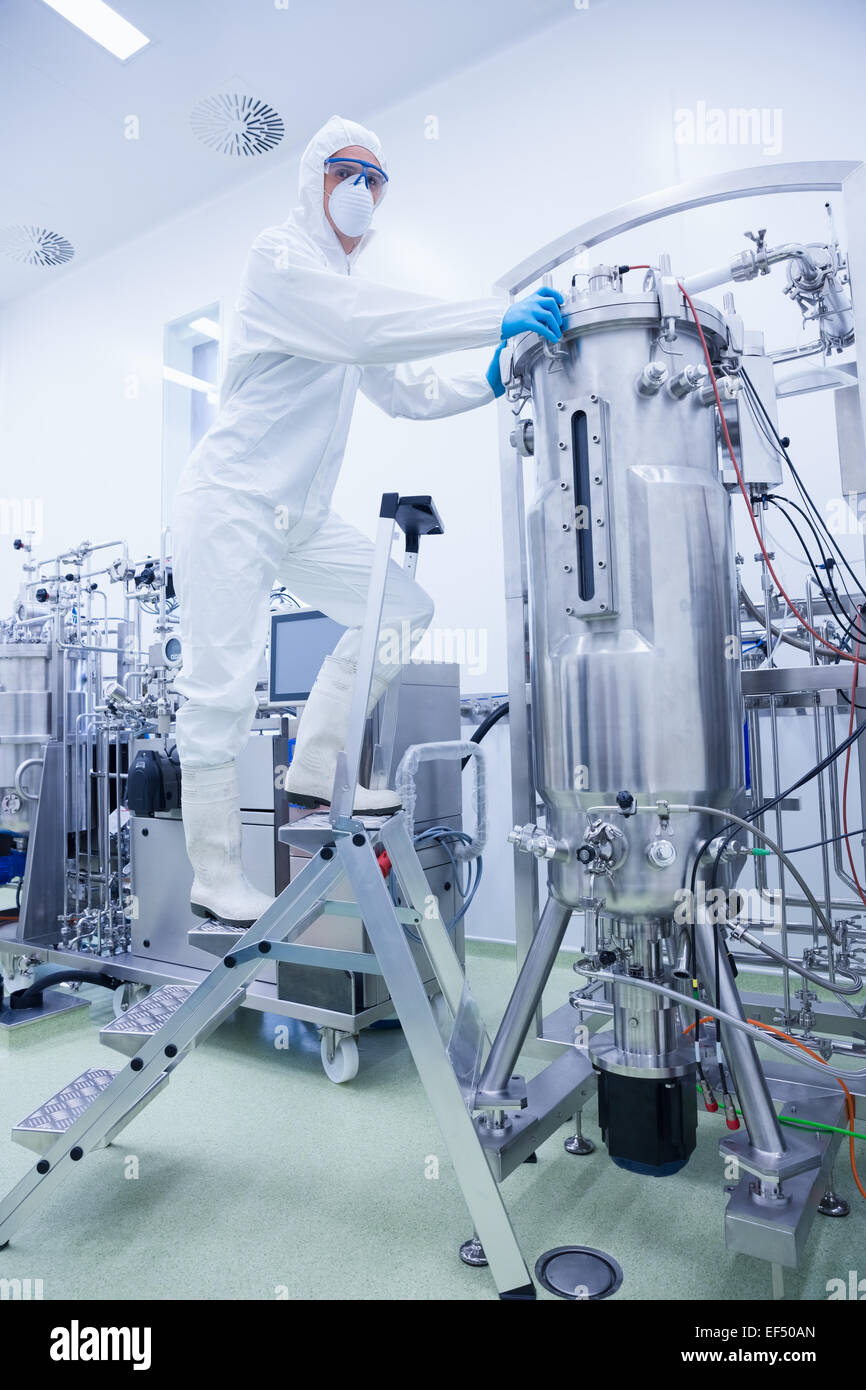 Scientist standing on ladder looking at the camera Stock Photo - Alamy