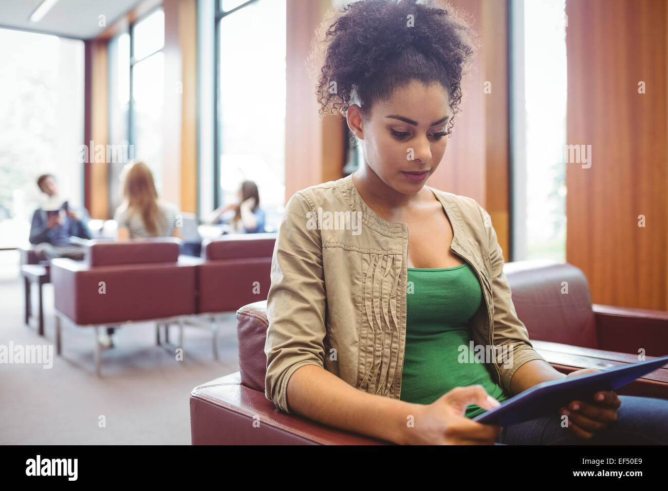 Attractive serious student using tablet Stock Photo - Alamy