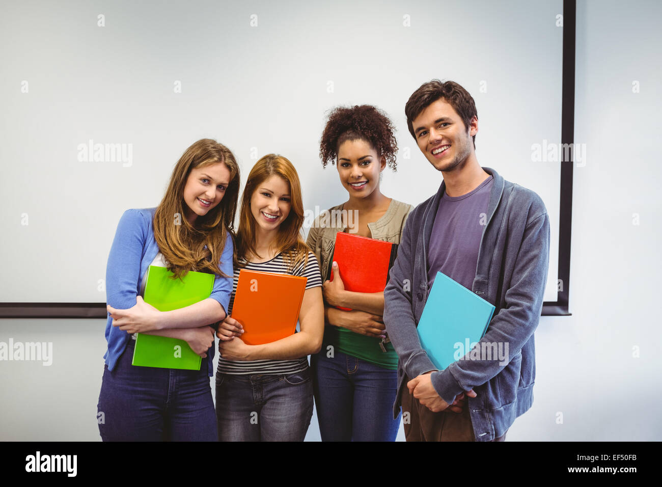 Smiling student holding notepad classmates hi-res stock photography and ...