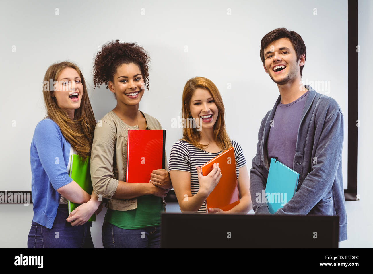 Smiling student holding notepad classmates hi-res stock photography and ...