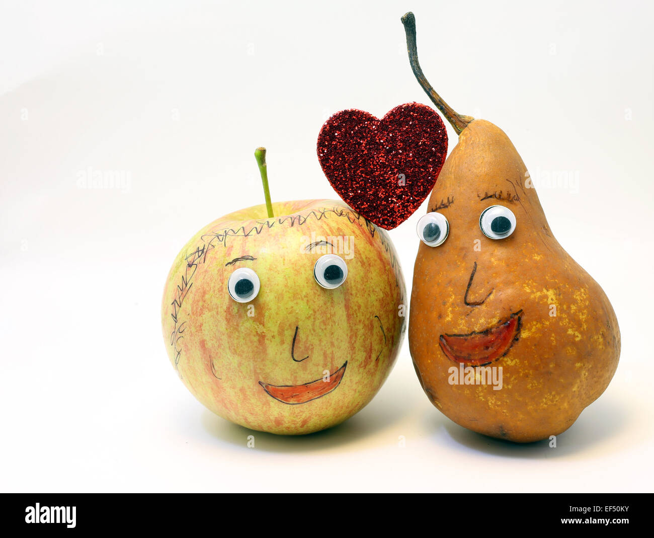 fun couple in love fruits apple and pear and big red heart Stock Photo ...