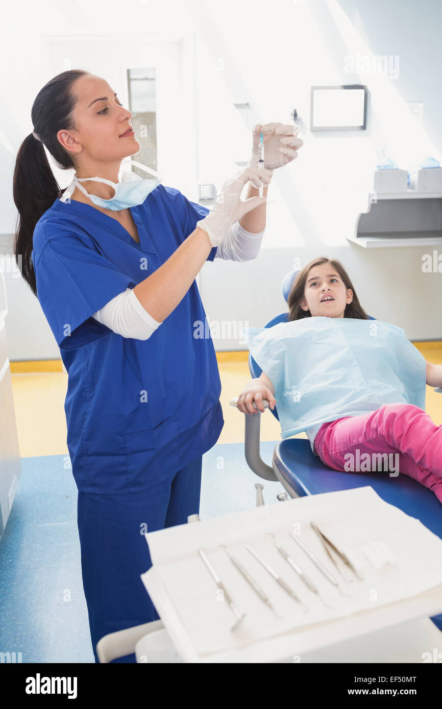 Pediatric dentist preparing an injection Stock Photo - Alamy
