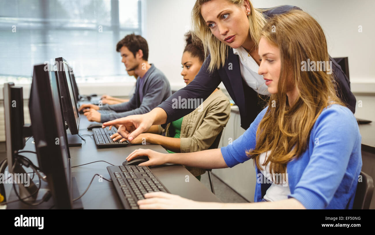 Male teacher helping female student hi-res stock photography and images ...