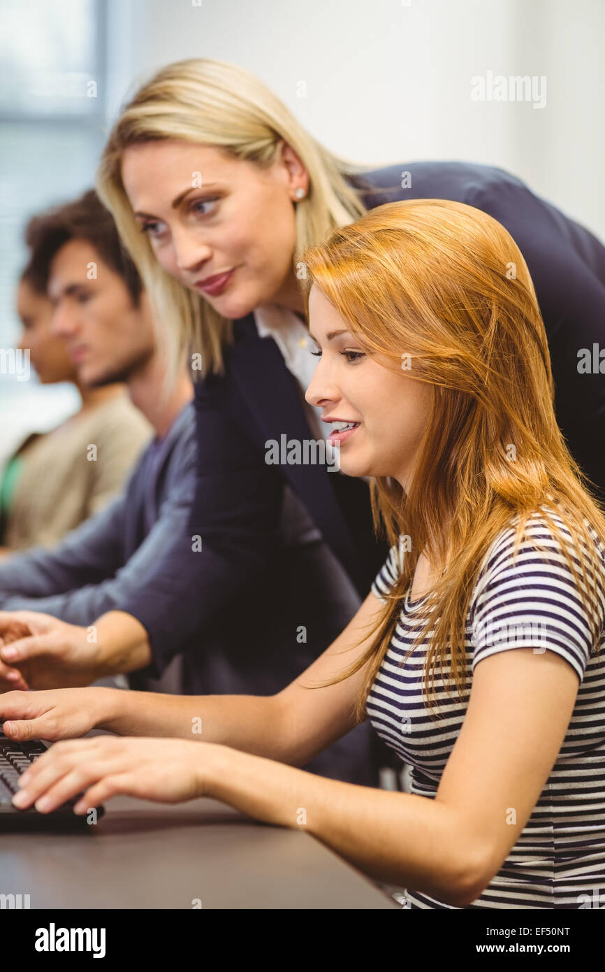 Teacher explaining something to male student Stock Photo - Alamy