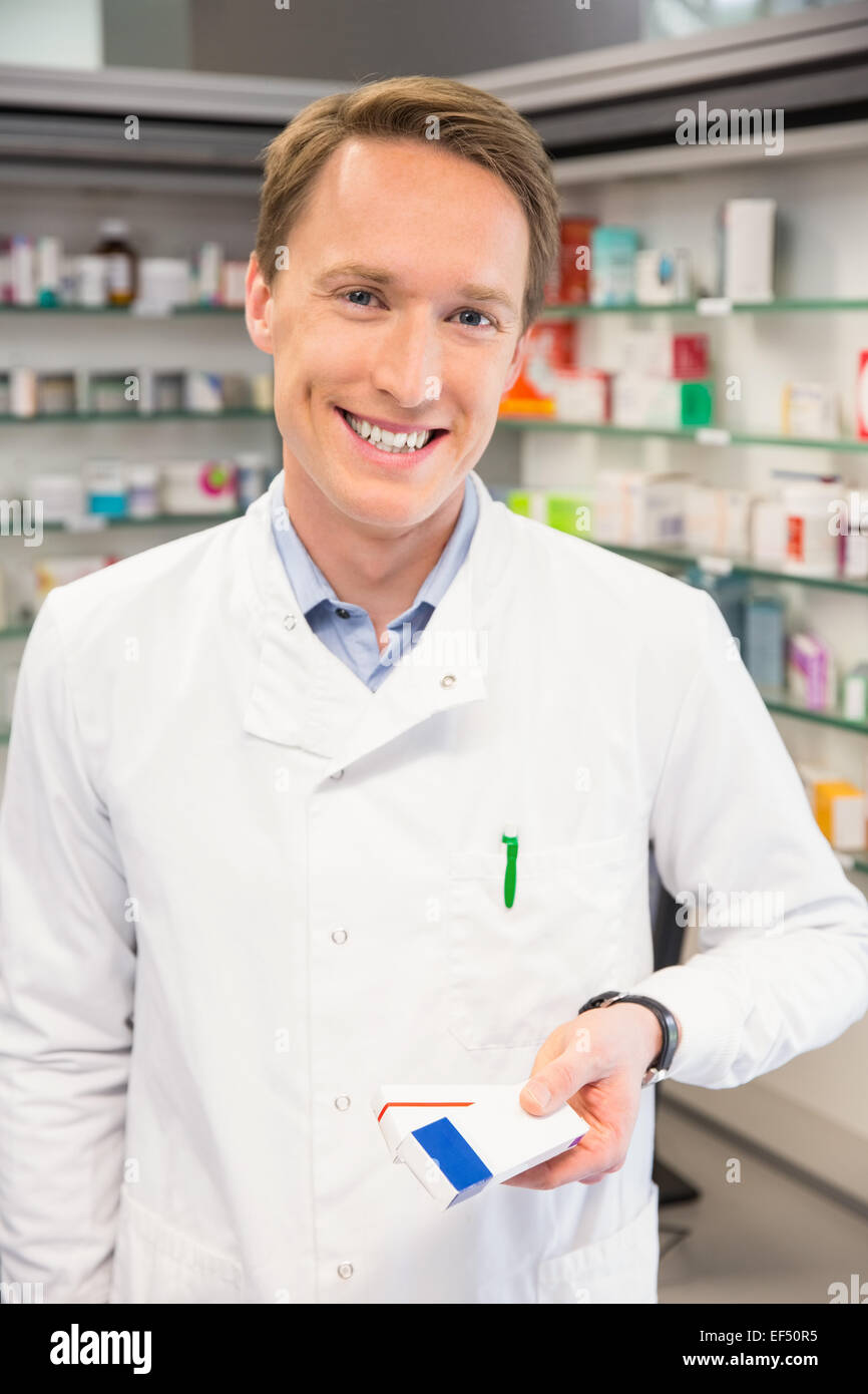 Happy pharmacist holding medicine boxes Stock Photo - Alamy