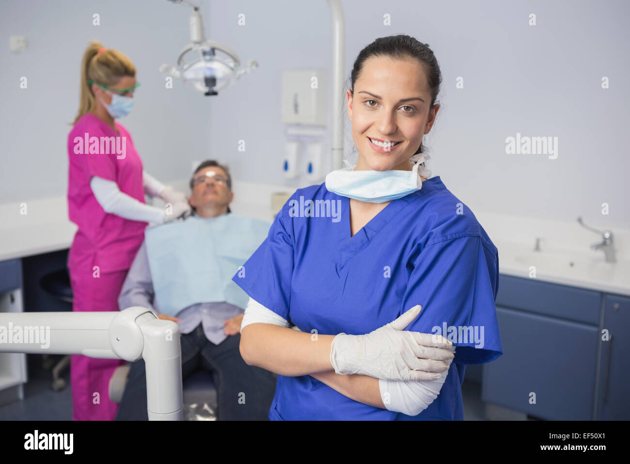 Smiling dentist with arms crossed Stock Photo - Alamy