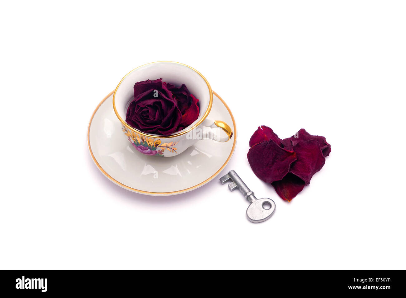 A cup of dried rose tea with key and heart on a white background Stock ...