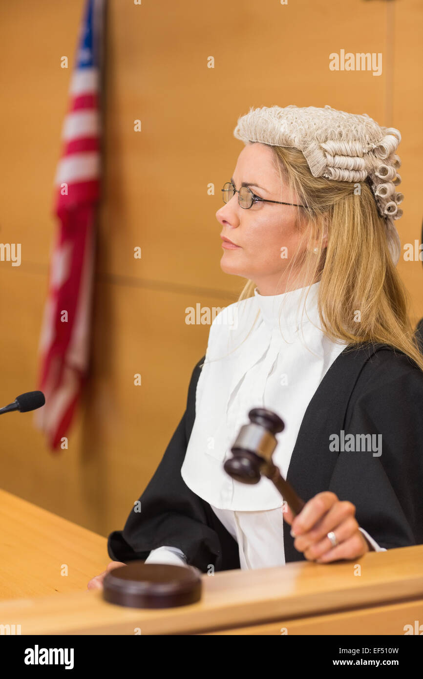 Stern judge sitting and listening Stock Photo - Alamy