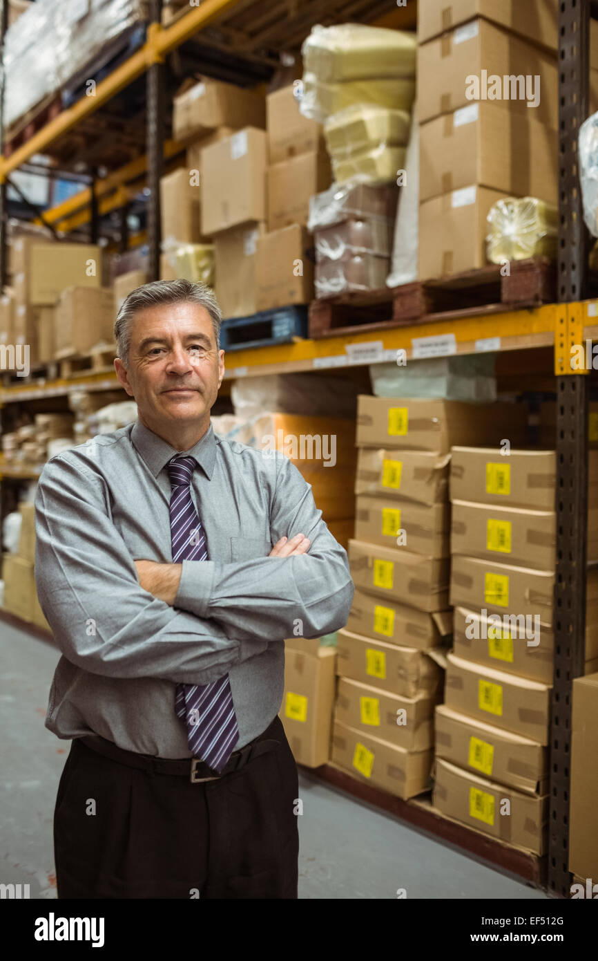 Smiling male manager with arms crossed Stock Photo - Alamy