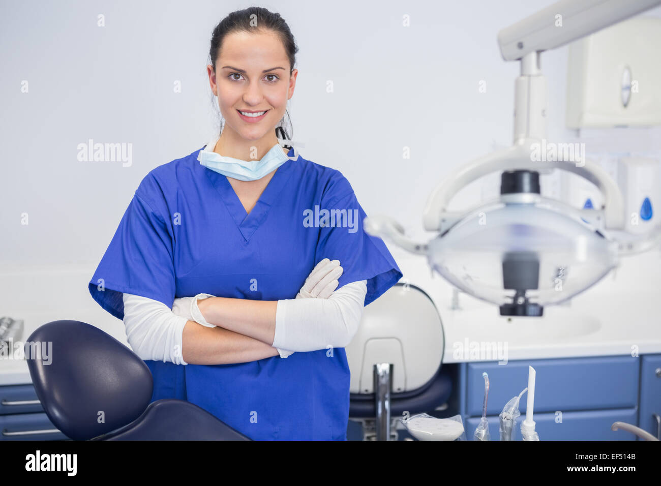 Portrait of a cheerful dentist with arms crossed Stock Photo - Alamy