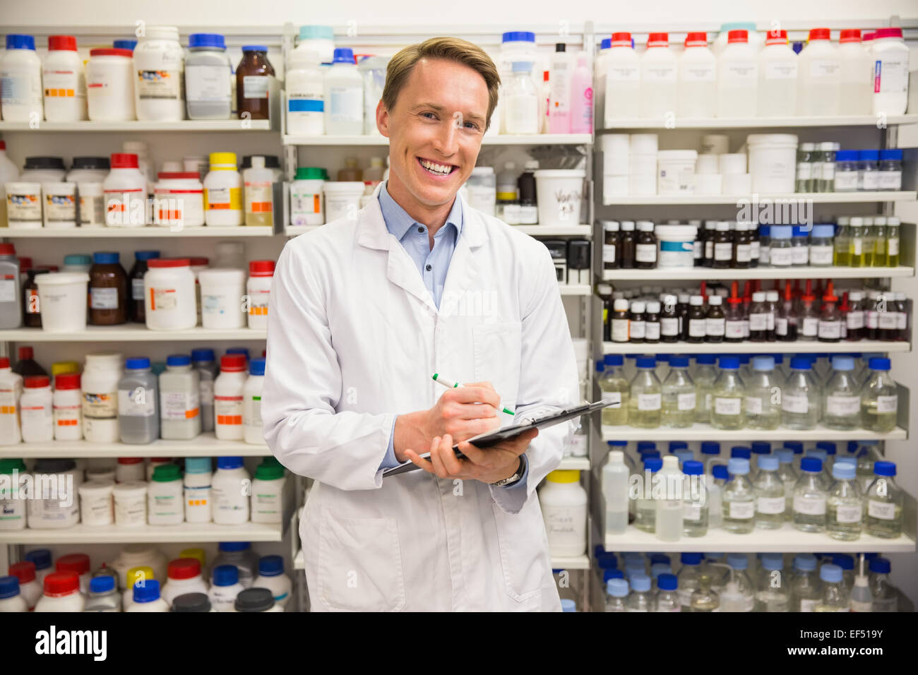 Handsome pharmacist smiling at camera Stock Photo - Alamy