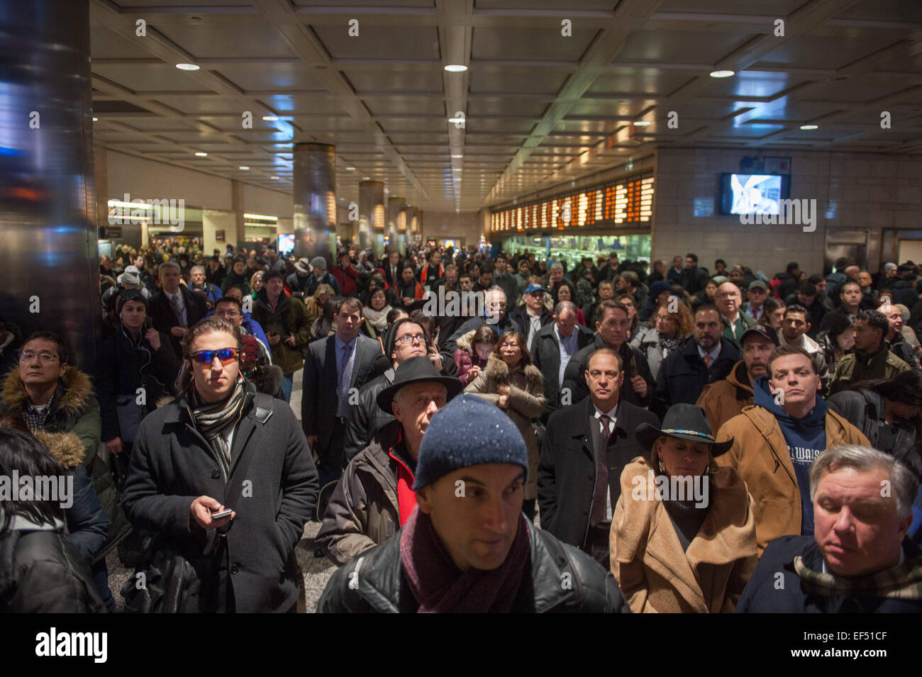 Manhattan, New York, USA. 26th Jan, 2015. Commuters look at the ...