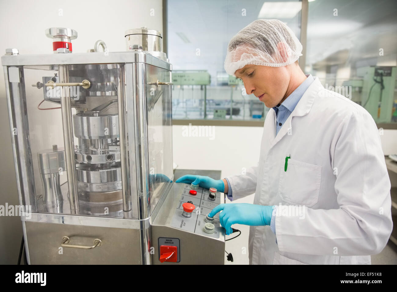 Pharmacist using machinery to make medicine Stock Photo - Alamy