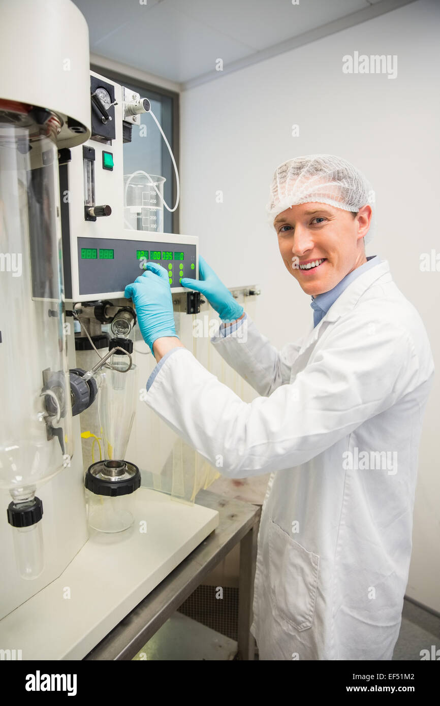 Pharmacist using machinery to make medicine Stock Photo - Alamy