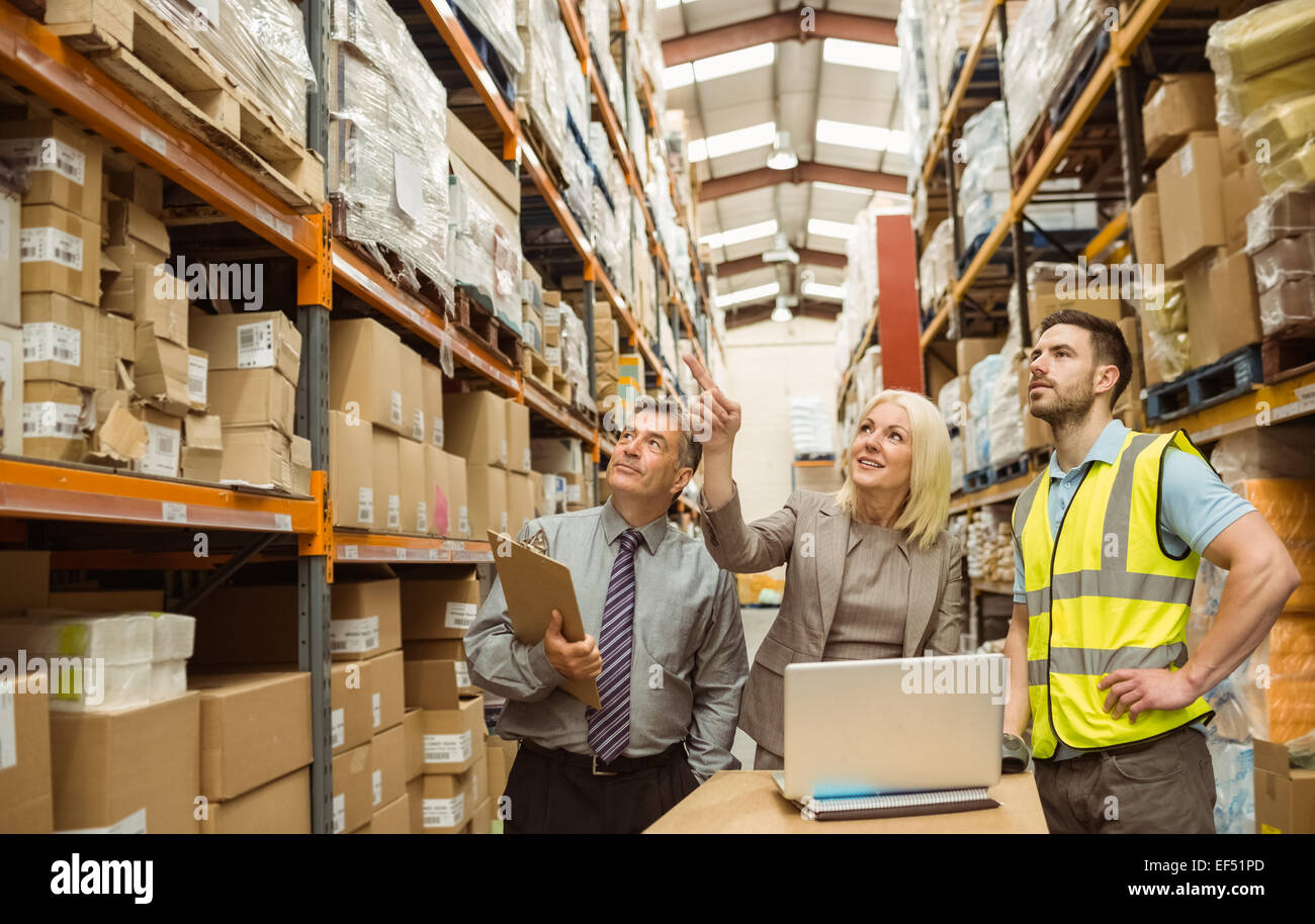 Cheerful warehouse team working together Stock Photo - Alamy
