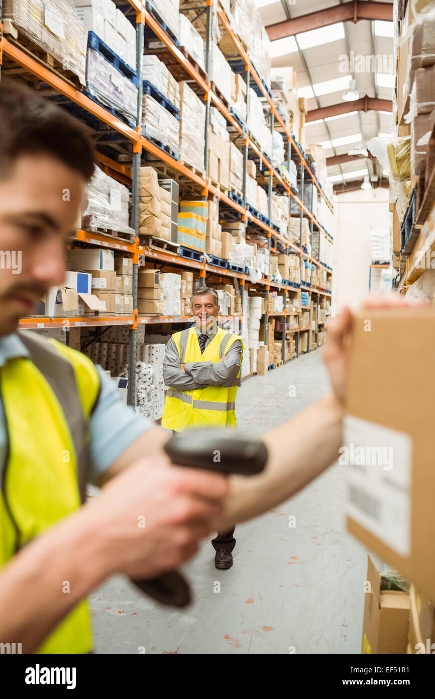 Warehouse worker scanning barcode on box Stock Photo - Alamy