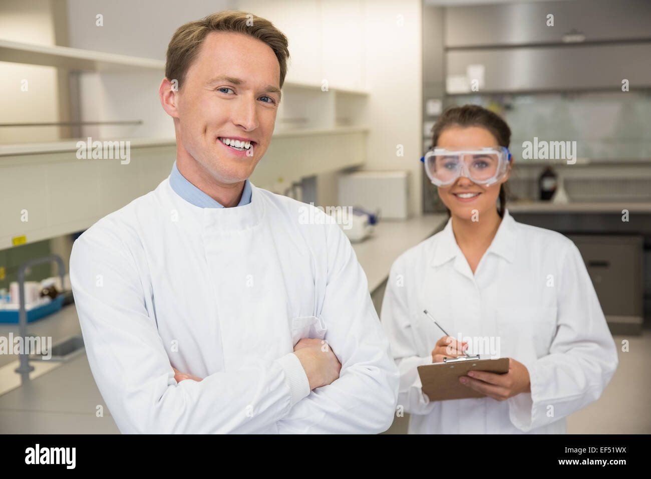 Team of pharmacists smiling at camera Stock Photo - Alamy