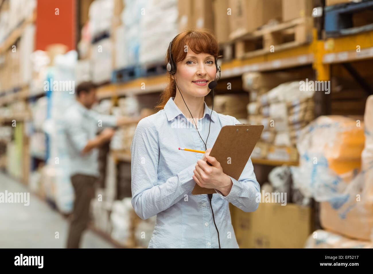 Woman clipboard writing in warehouse hi-res stock photography and ...