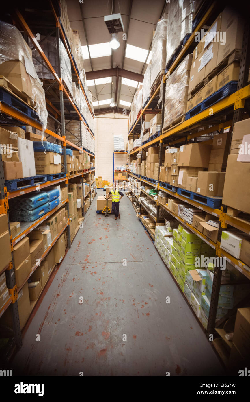 Worker with trolley of boxes Stock Photo - Alamy