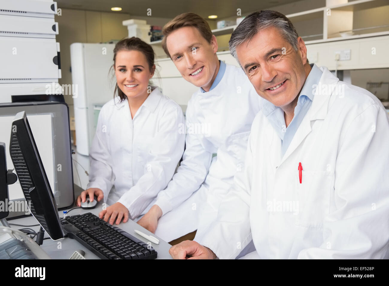 Team of scientists working together Stock Photo - Alamy