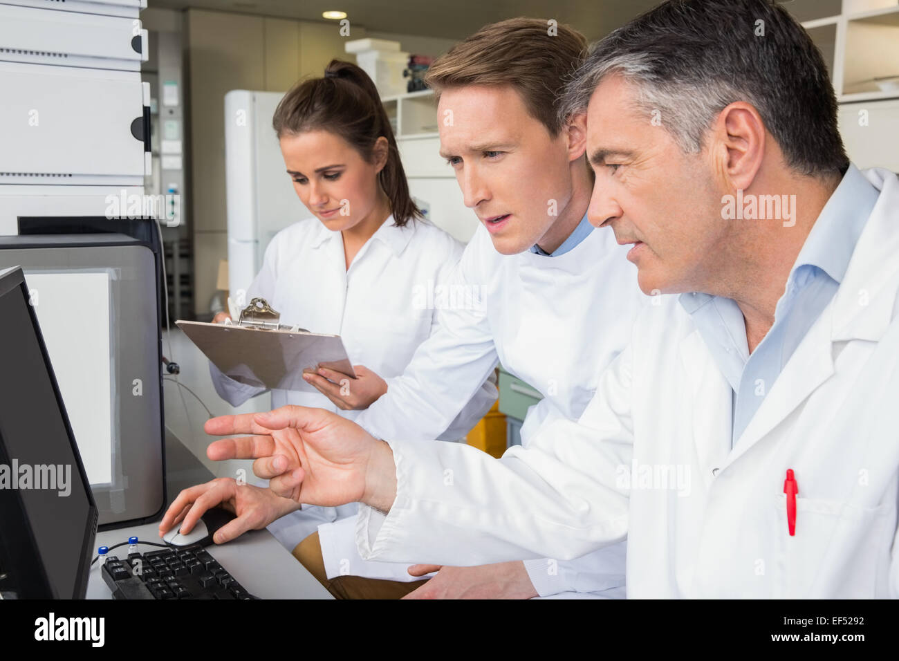 Scientists working using microscope hi-res stock photography and images ...