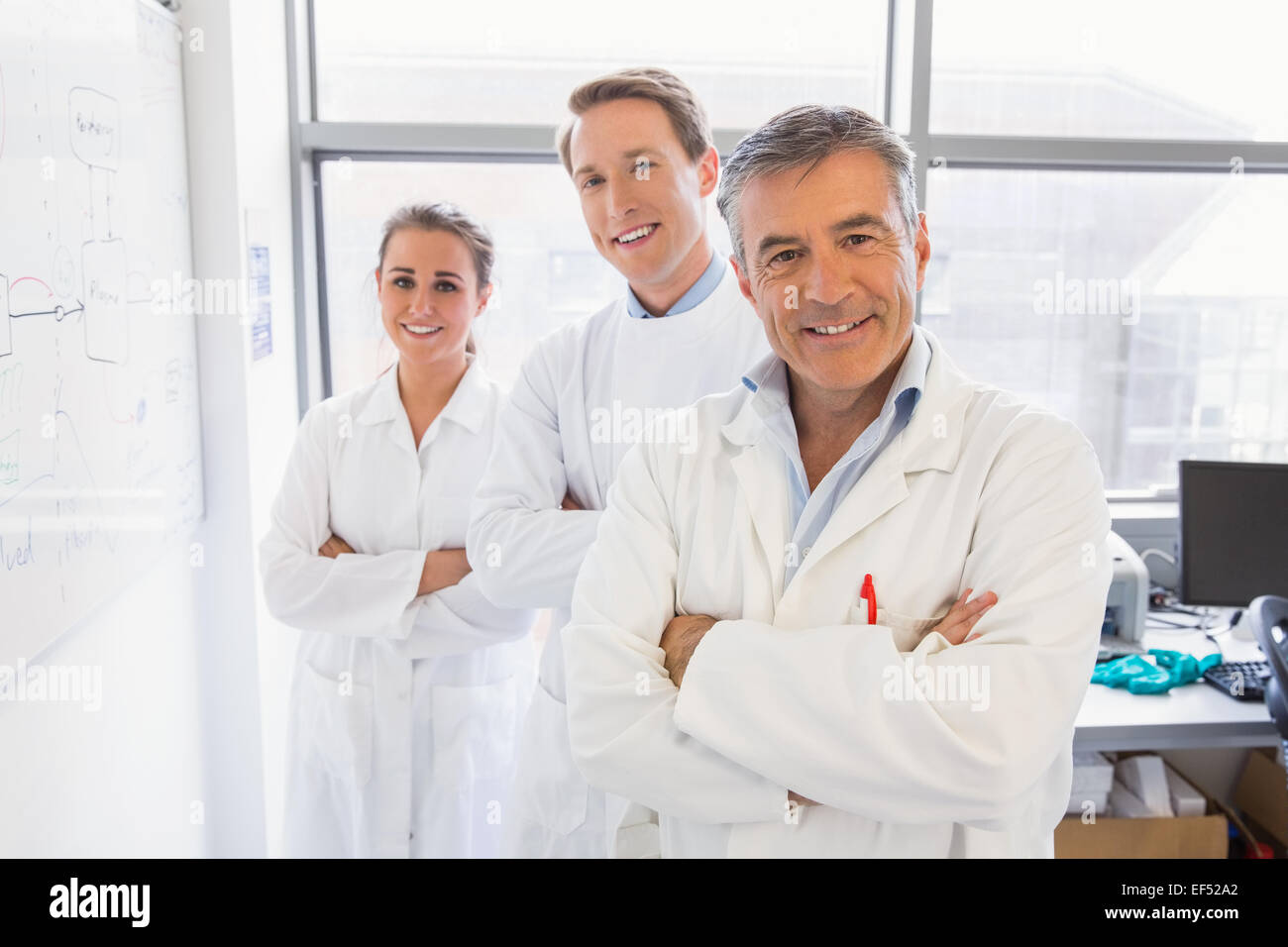 Science students and lecturer smiling at camera Stock Photo - Alamy