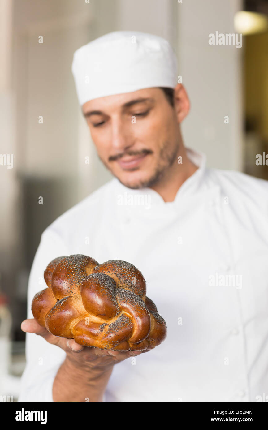 Baker checking freshly baked bread Stock Photo - Alamy