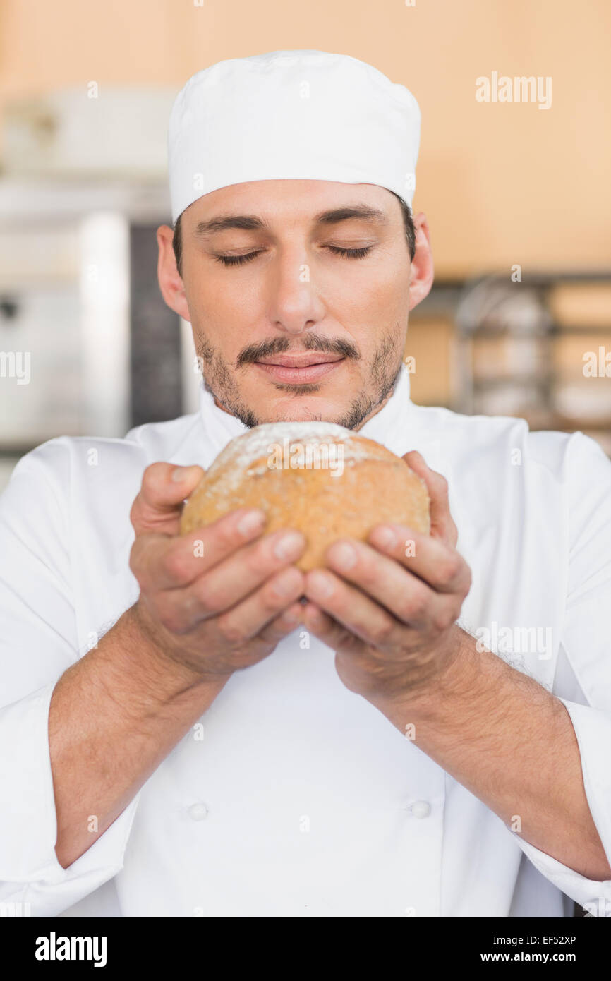 Baker smelling a freshly baked loaf Stock Photo - Alamy