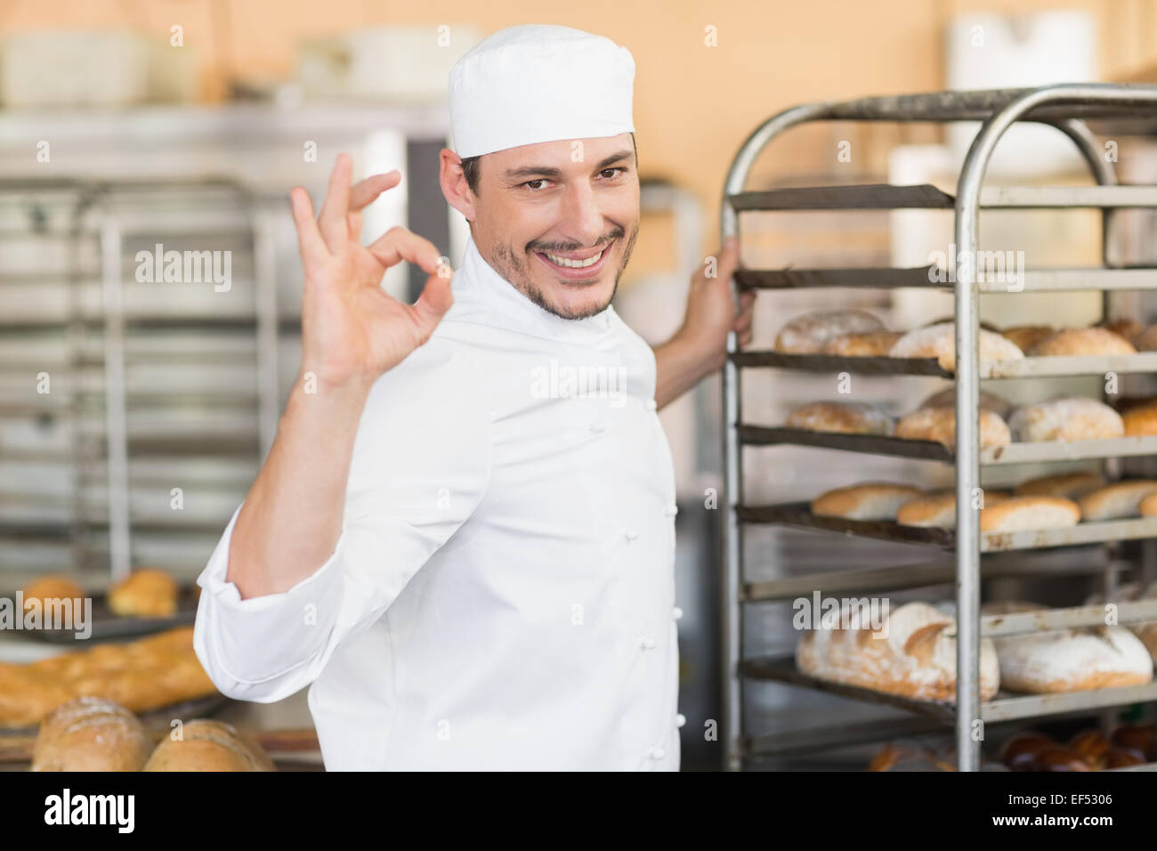 Smiling baker making ok sign with hand Stock Photo - Alamy