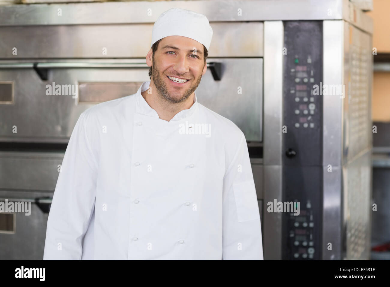 Smiling baker looking at camera Stock Photo - Alamy
