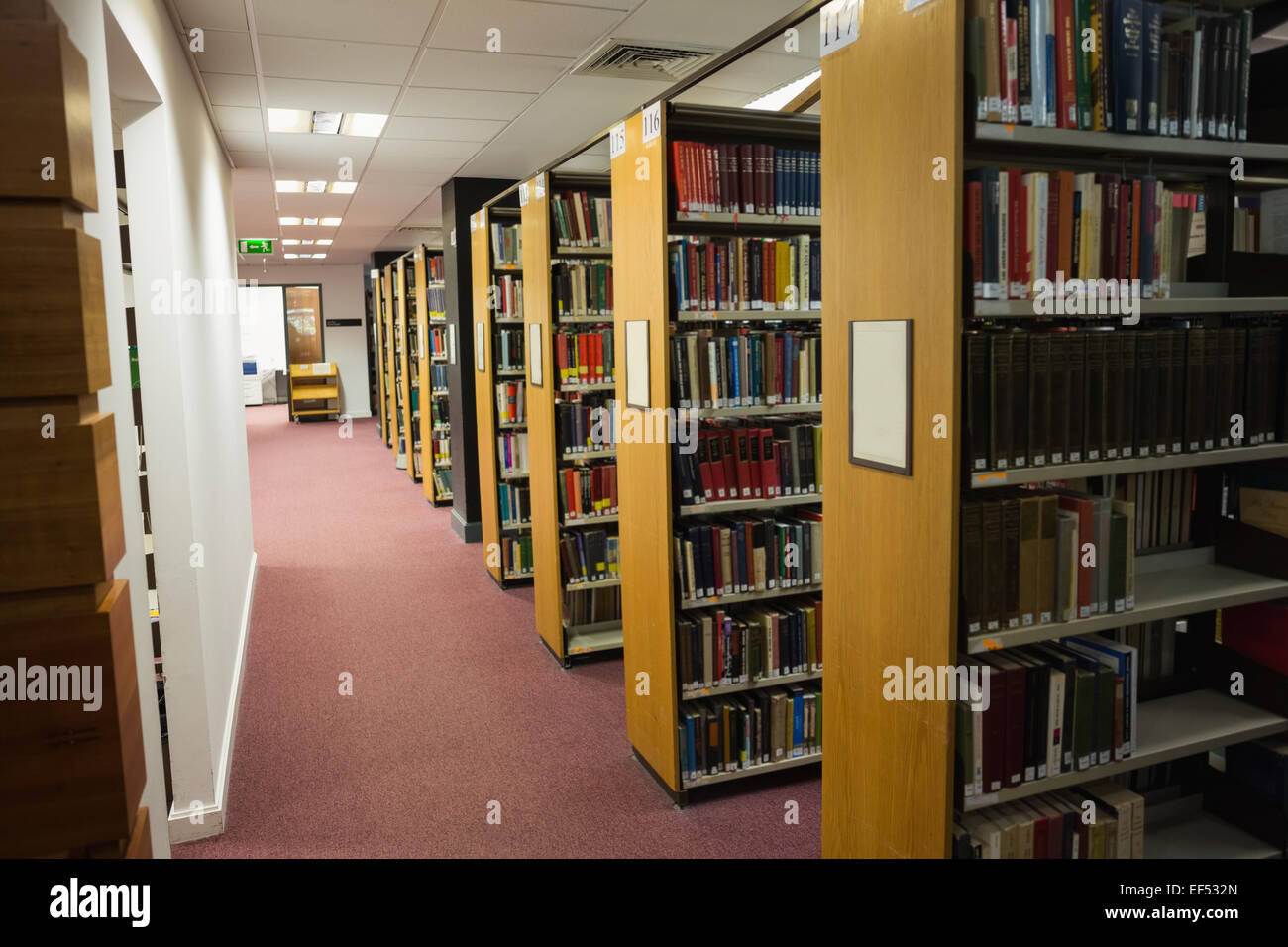Volumes of books on bookshelf in library Stock Photo - Alamy