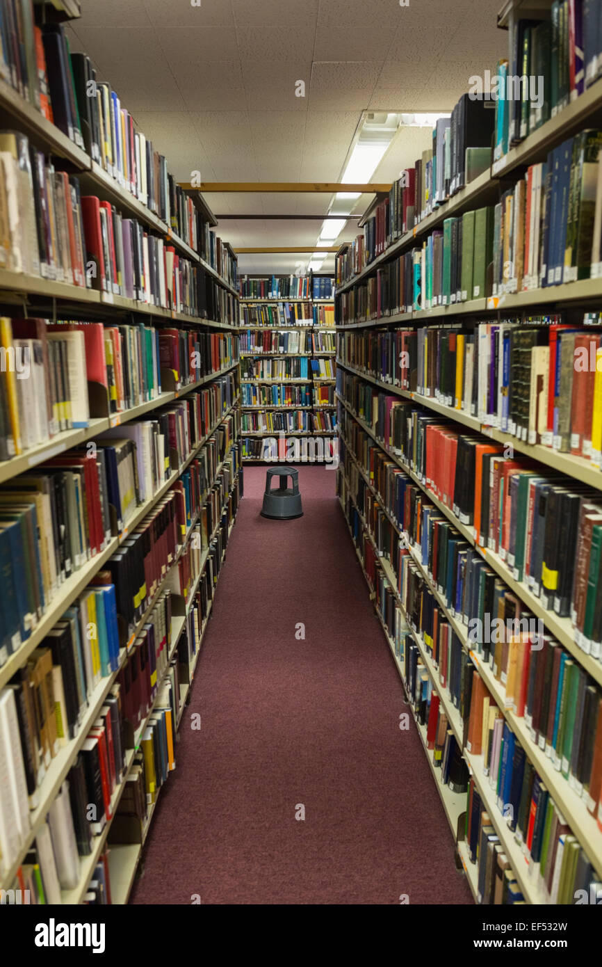 Volumes of books on bookshelf in library Stock Photo - Alamy