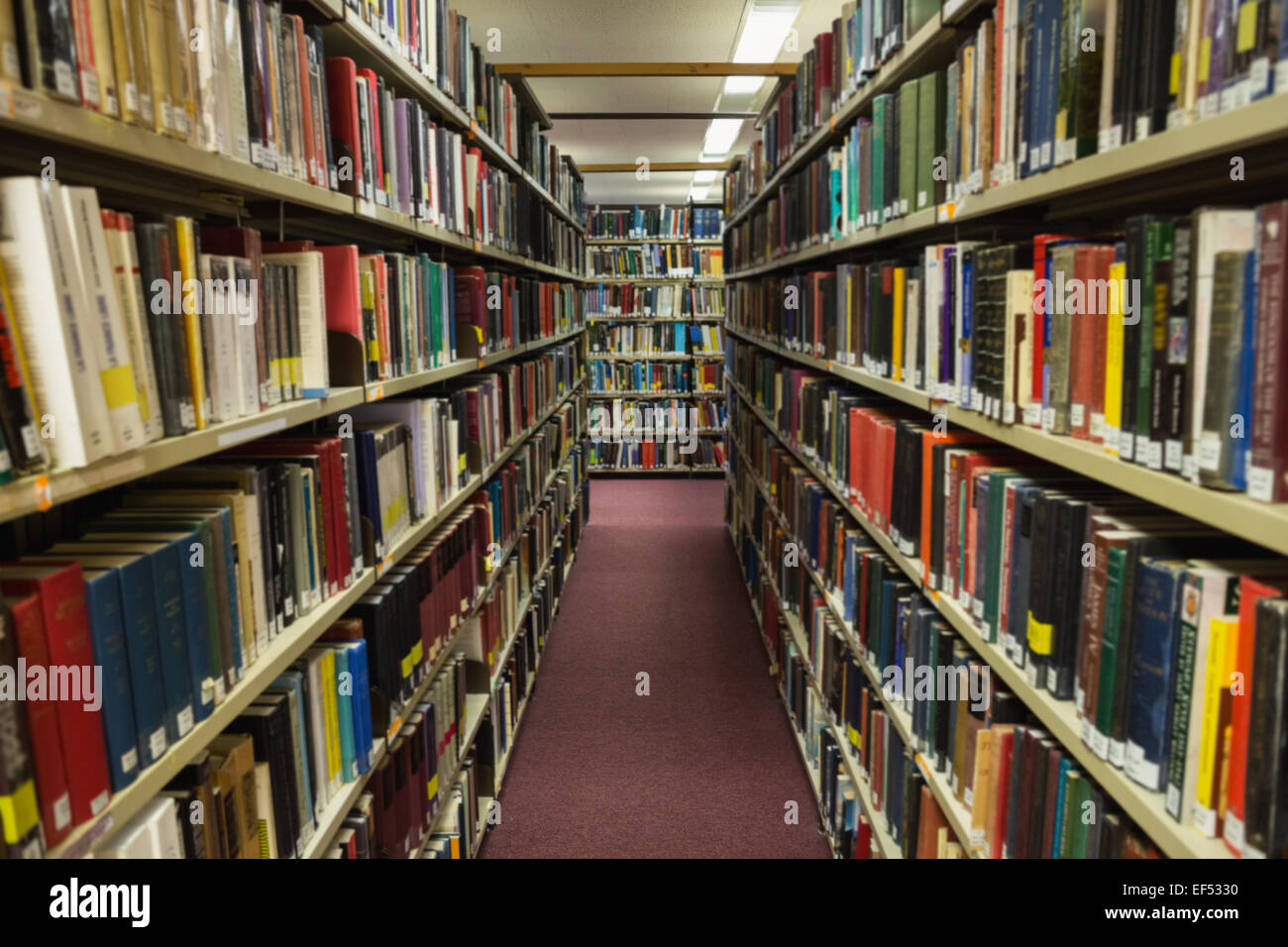 Volumes of books on bookshelf in library Stock Photo - Alamy