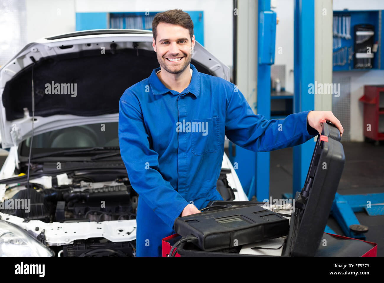 Mechanic smiling at the camera Stock Photo - Alamy