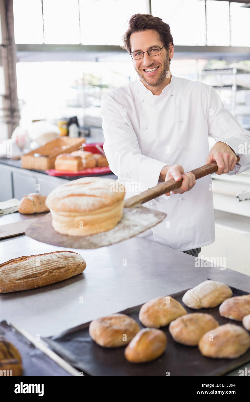Baker showing freshly baked loaf Stock Photo - Alamy