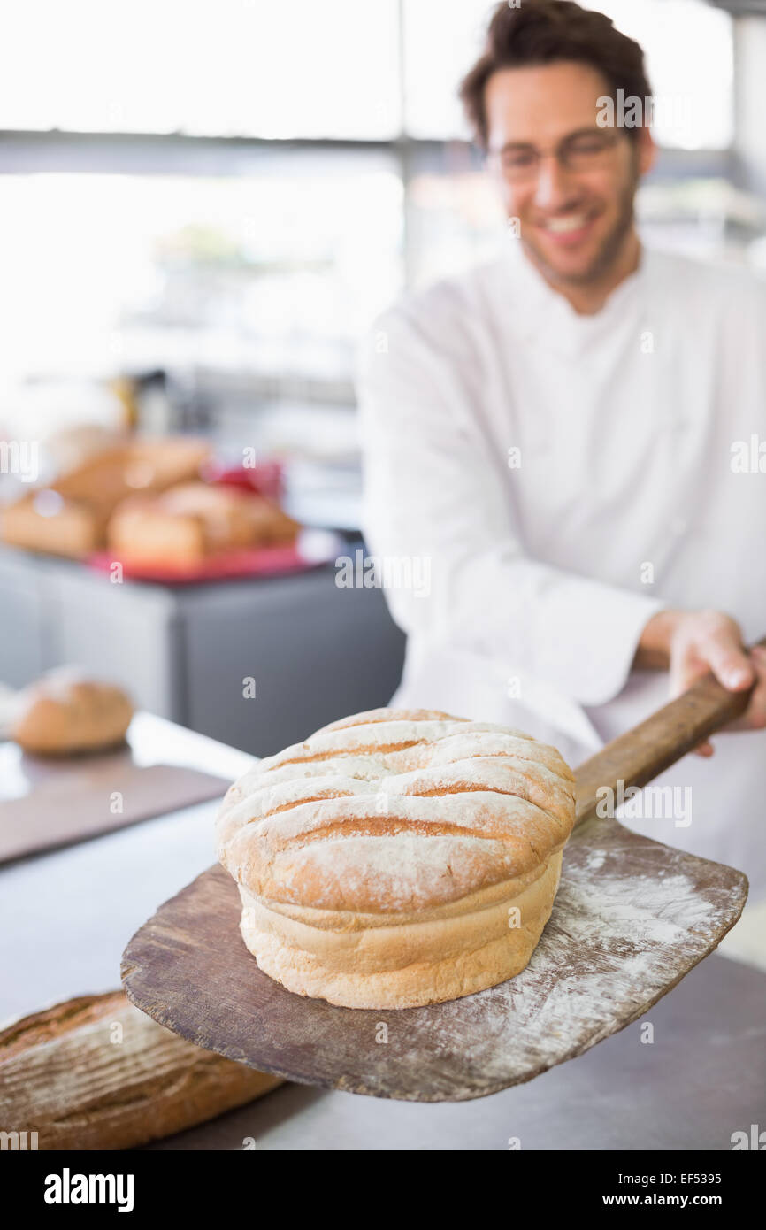 Baker showing freshly baked loaf Stock Photo - Alamy