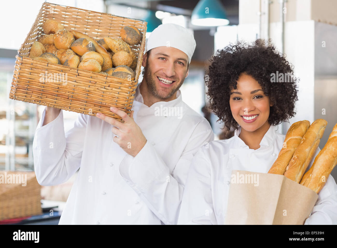 Team of bakers smiling at camera Stock Photo - Alamy