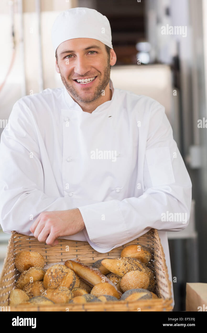 Happy baker with basket of bread Stock Photo - Alamy