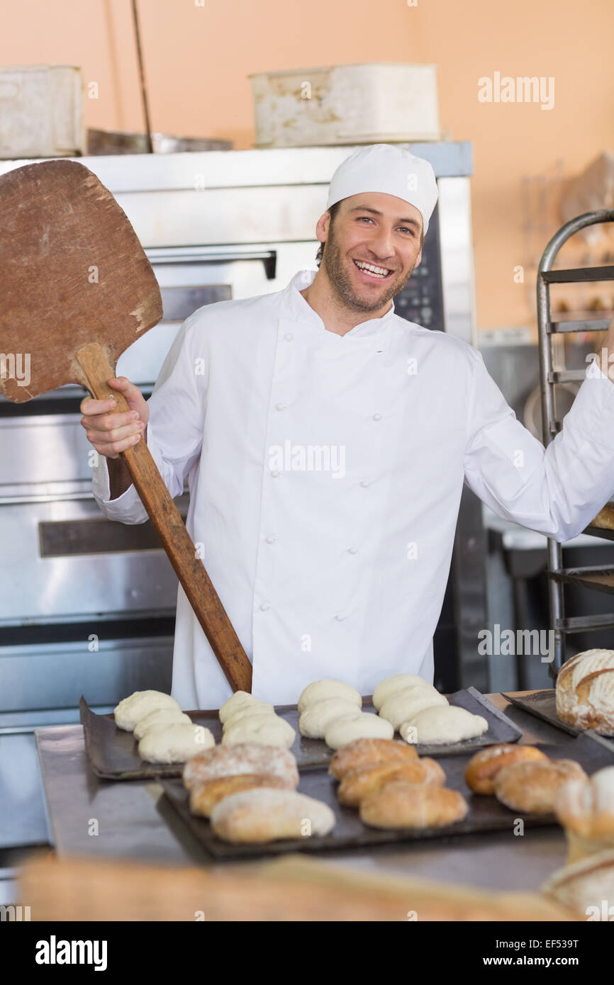Happy baker smiling at camera Stock Photo - Alamy